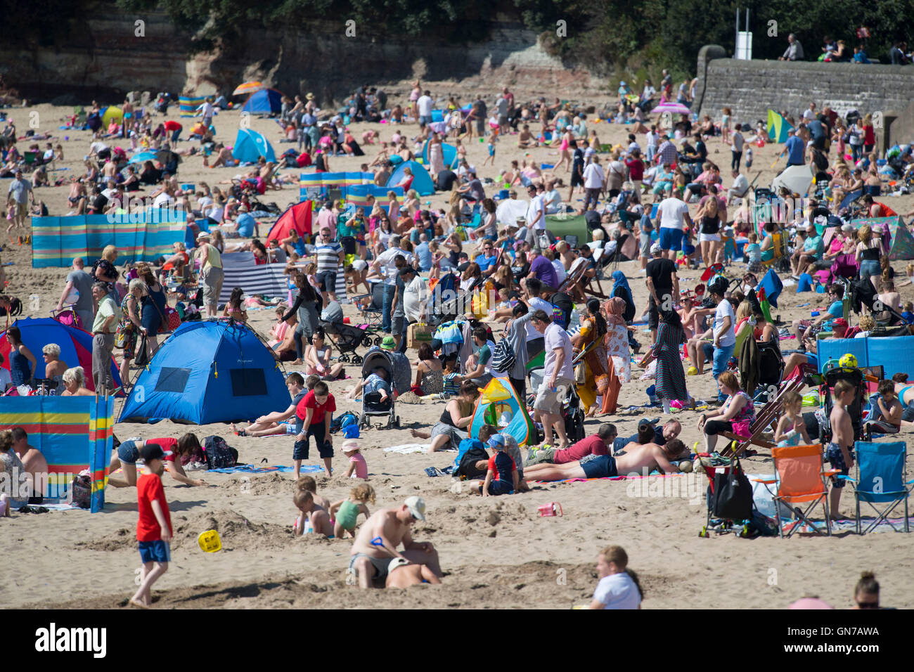 A busy Whitmore Bay traditional UK holiday beach at Barry Island, South ...