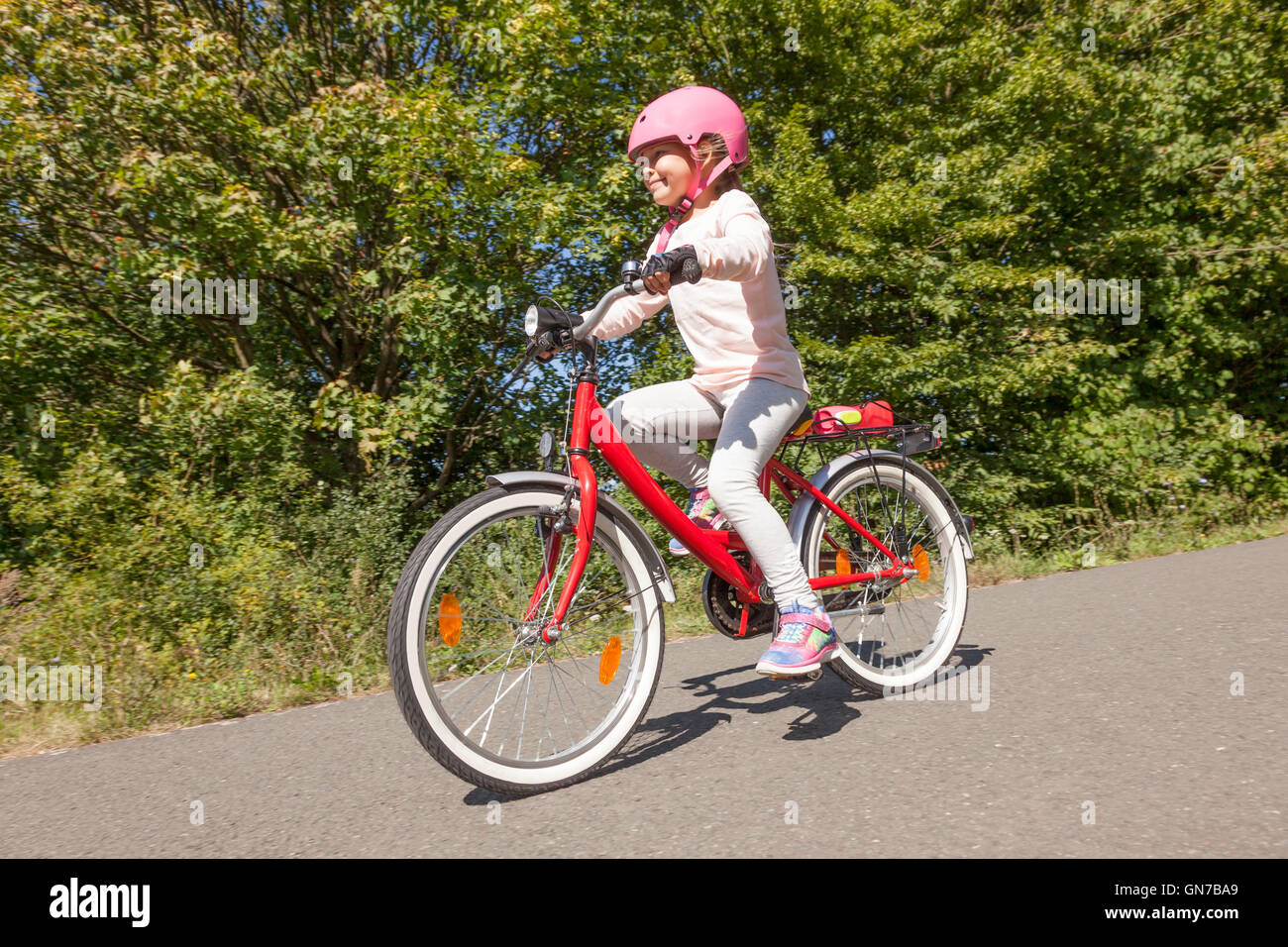 Girl riding bicycle Stock Photo - Alamy