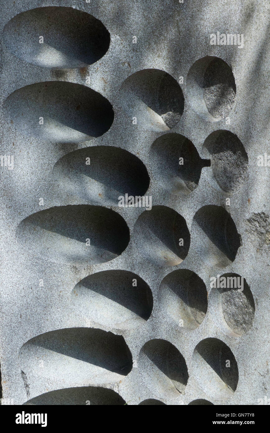 drill holes in stone creating design Stock Photo - Alamy