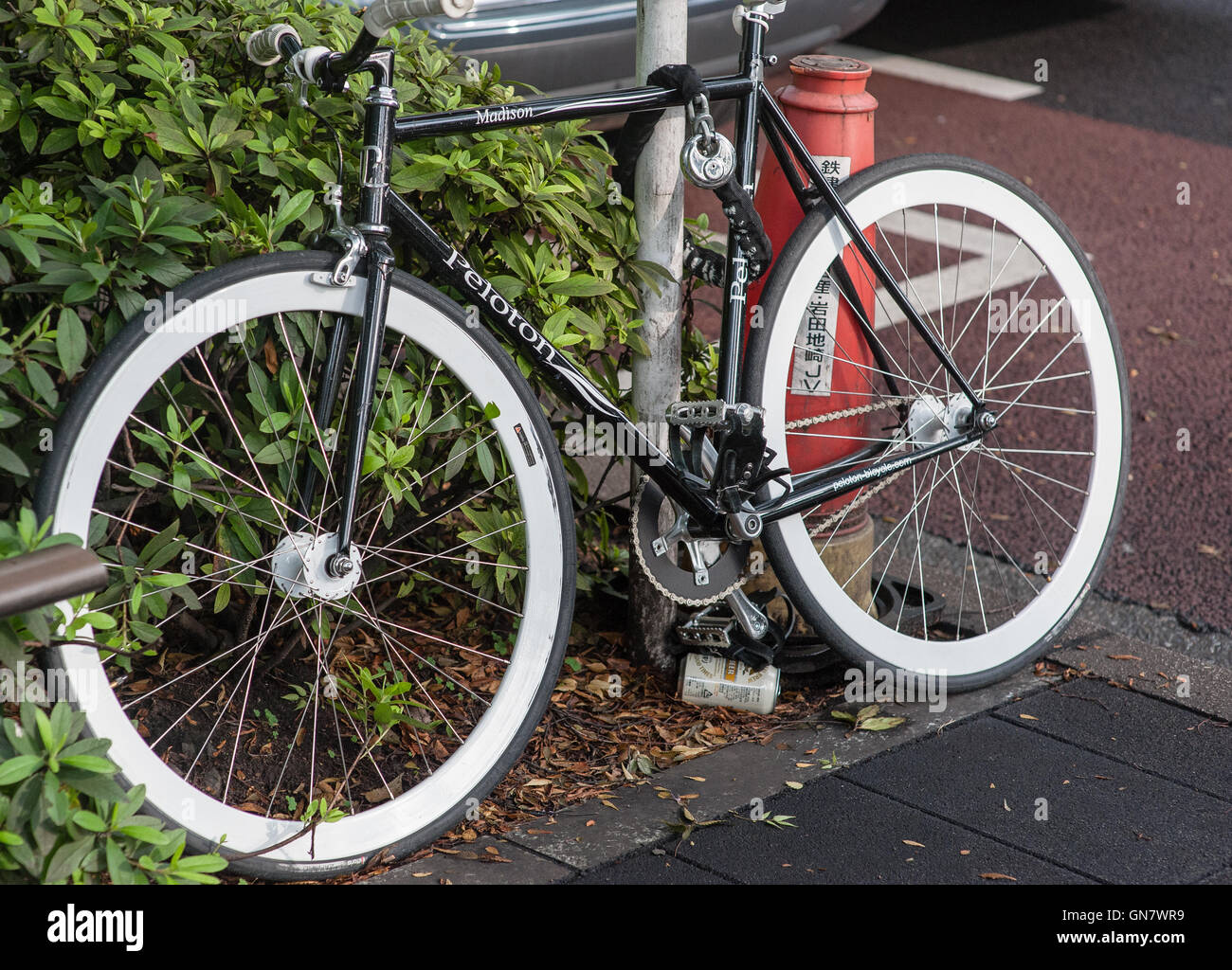 Bike chained to post Stock Photo - Alamy