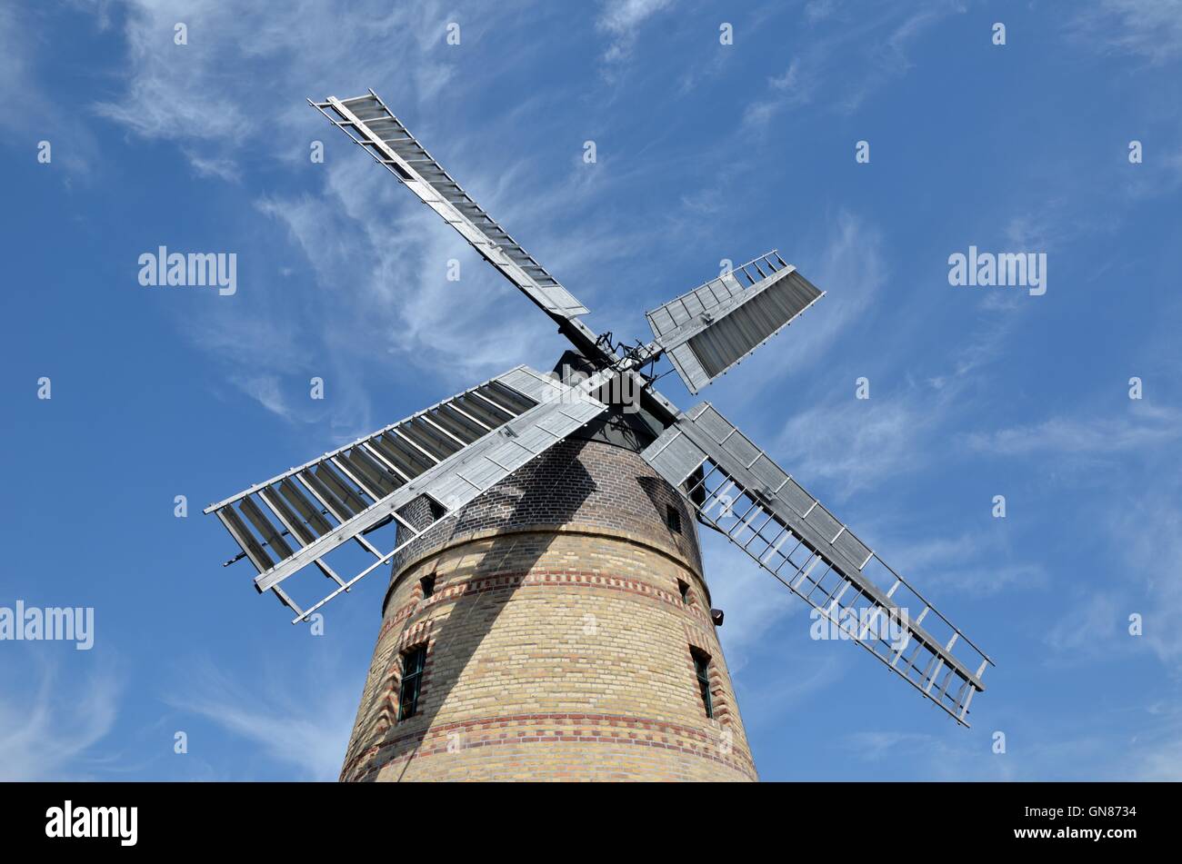 brick building old wind mill cirrostratus Stock Photo - Alamy