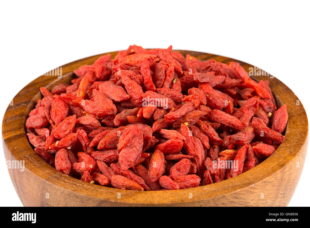 Chinese goji berries in wooden bowl close up on white background Stock ...