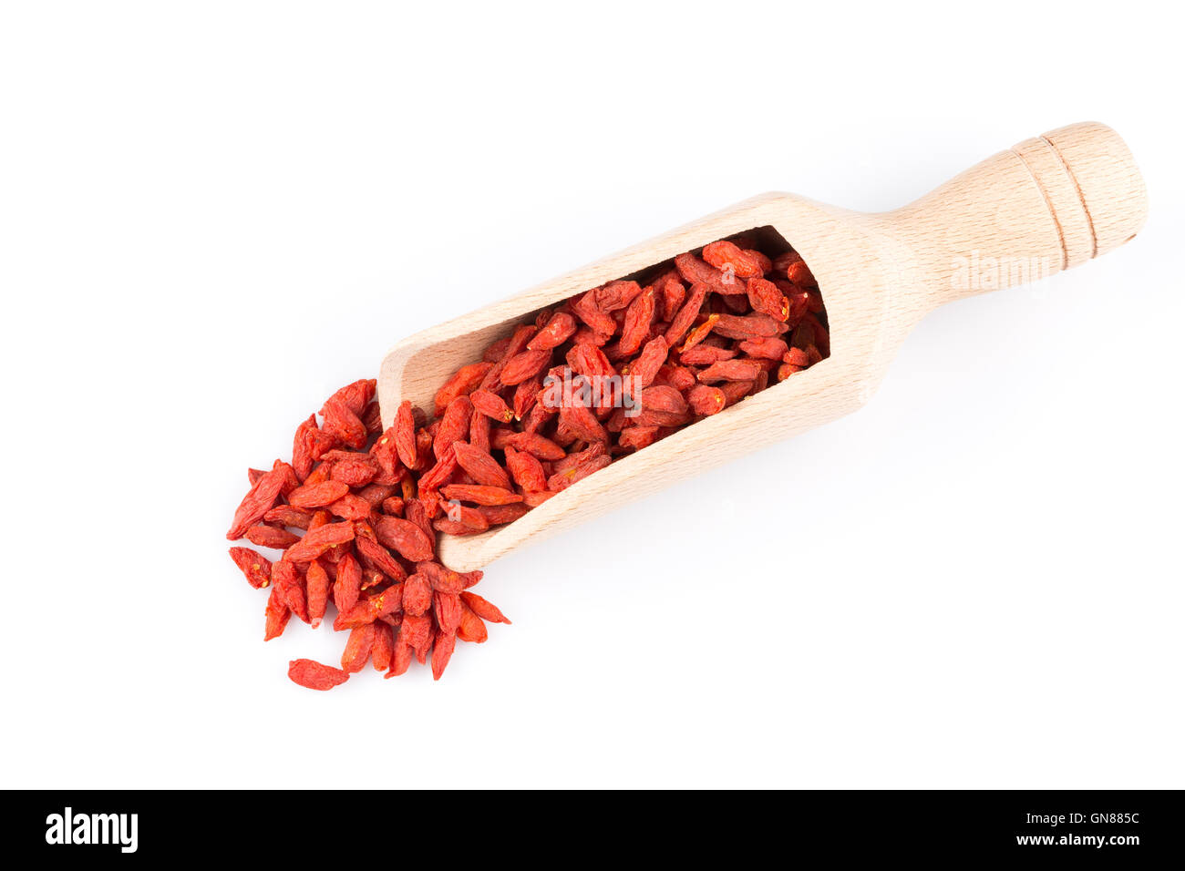Chinese goji berries in wooden scoop close up on white background Stock ...
