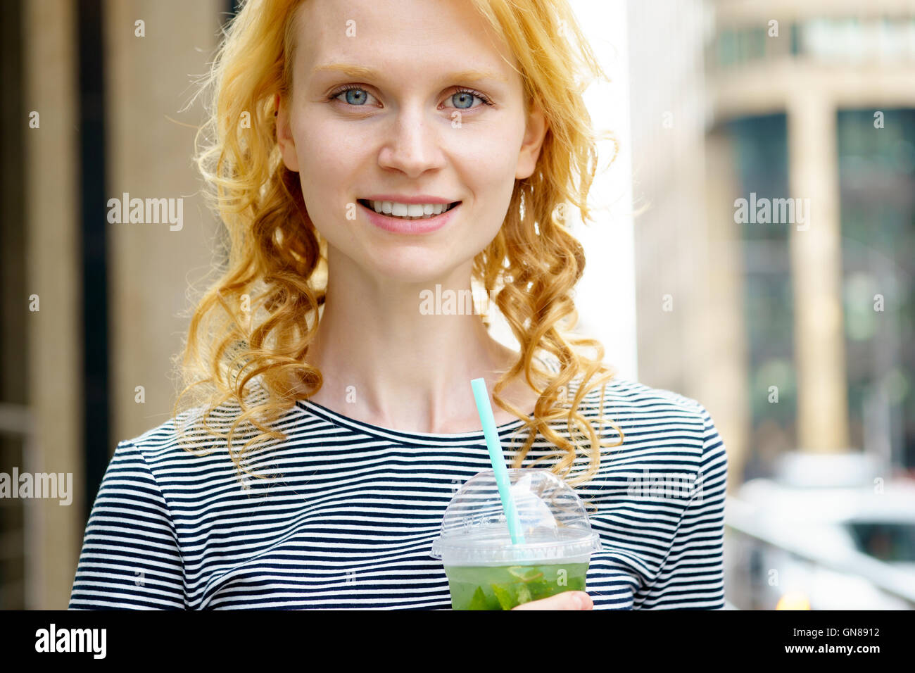 Closeup portrait of attractive blue-eyed woman with cold drink Stock ...