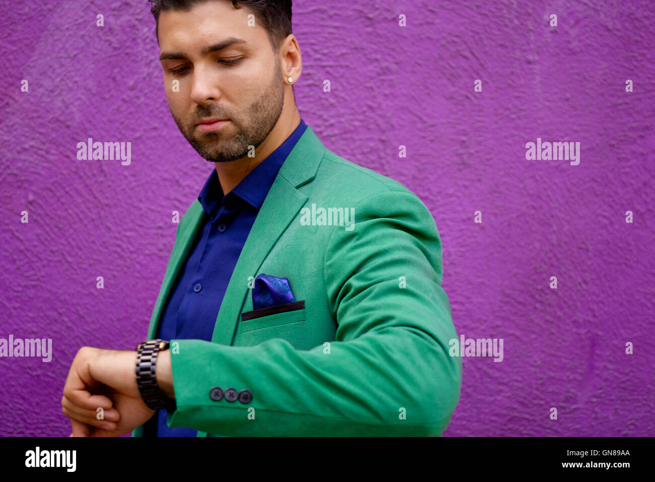 Modern stylish man watching the time on his watch Stock Photo - Alamy