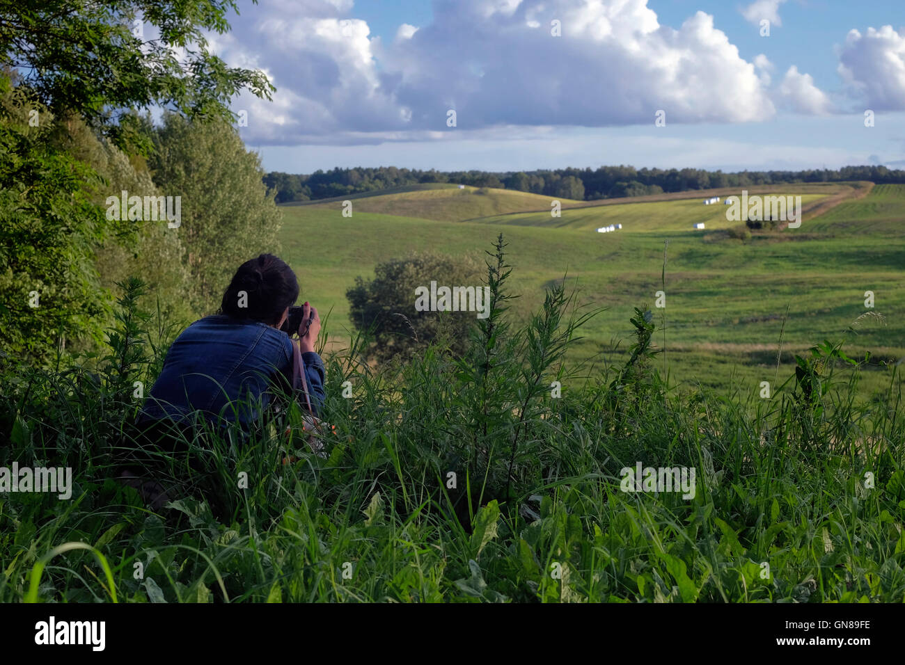 A young Polish woman snapping rural scenery in the administrative ...