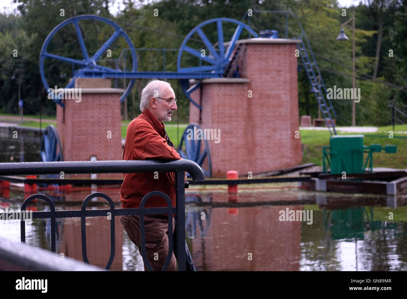 A Polish man at a cable winch and water lock platform in Buczyniec in ...