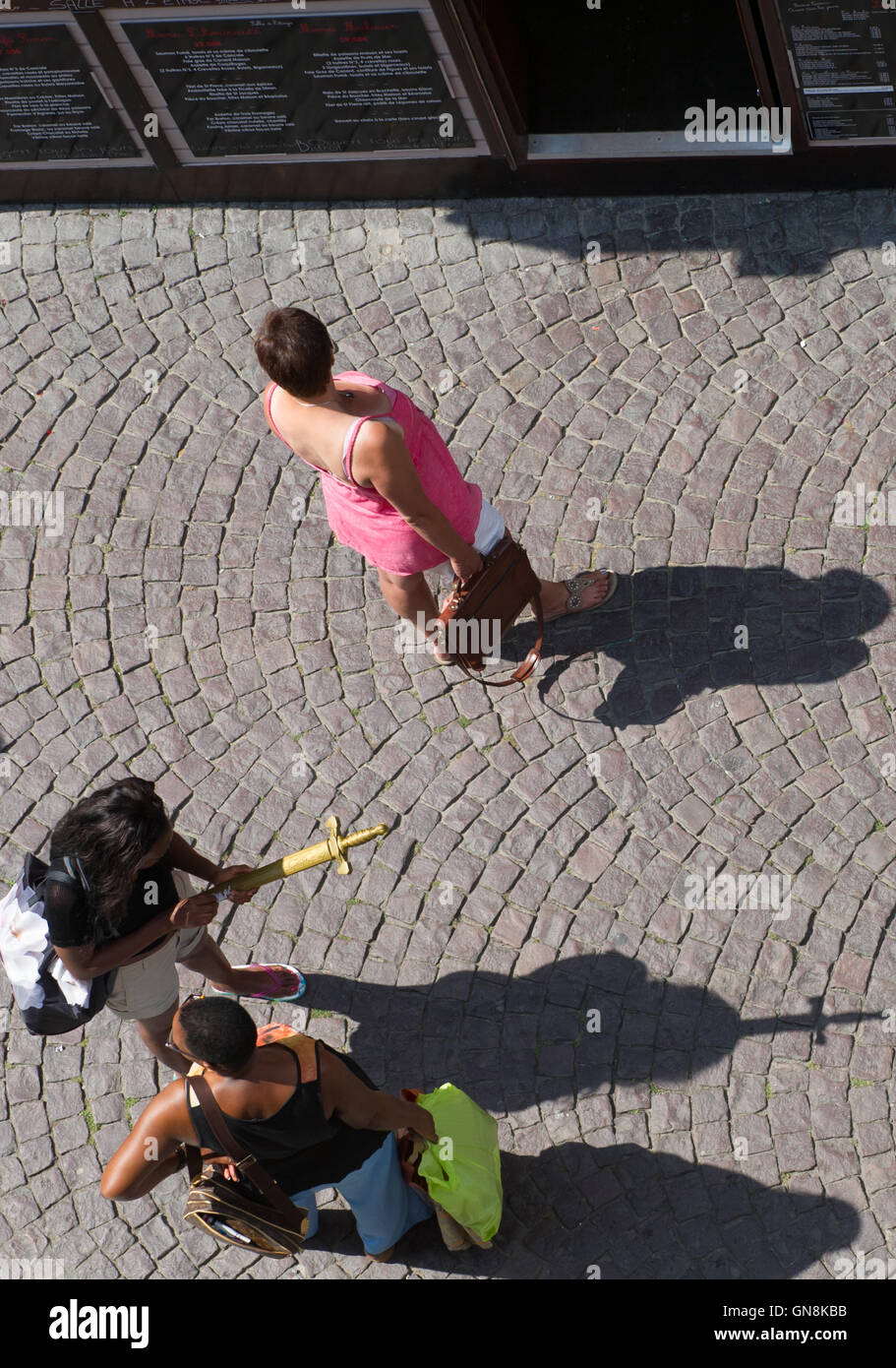 Three women and their shadows onto a cobbled street Stock Photo - Alamy