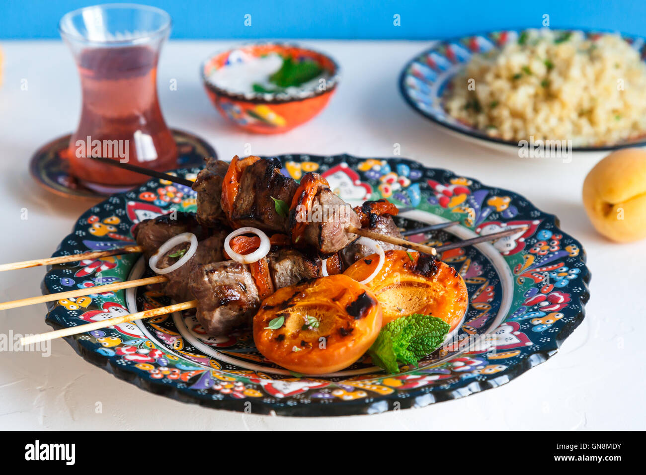 Lamb kebab with dried apricot, served with bulgur and rose tea Stock ...