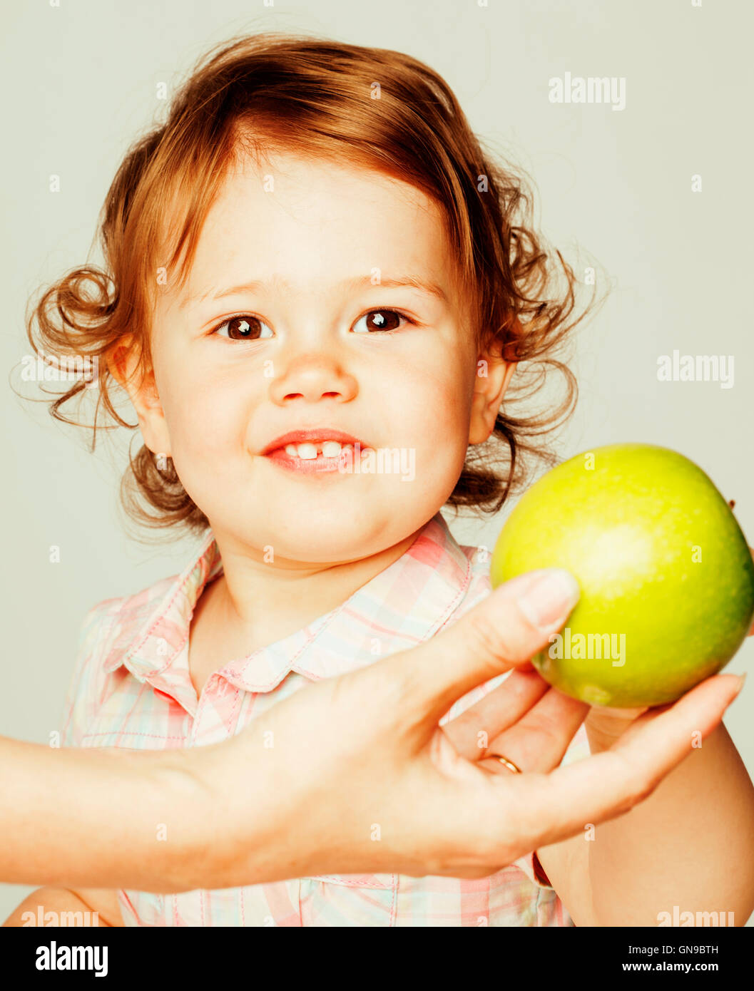 little cute baby girl pointing isolated on white close up with green ...