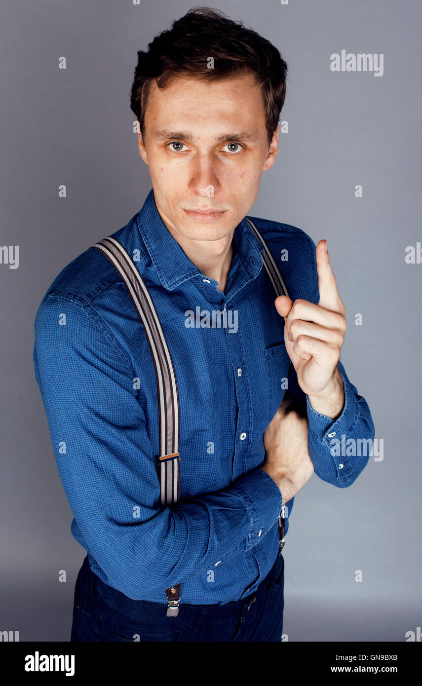 young goofy man with pimples pointing in studio Stock Photo - Alamy