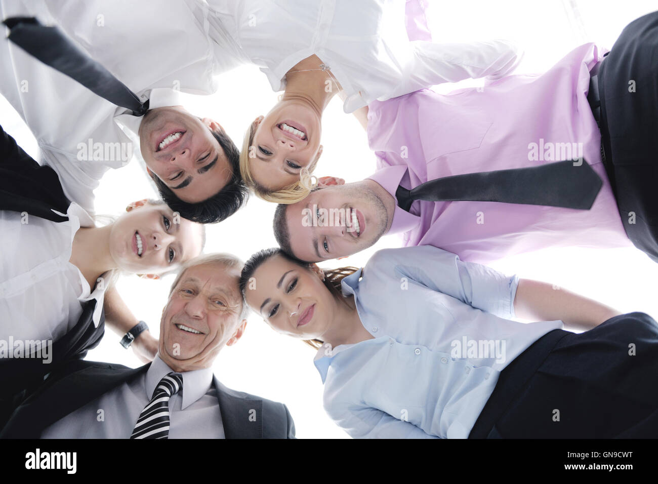 business people with their heads together Stock Photo - Alamy
