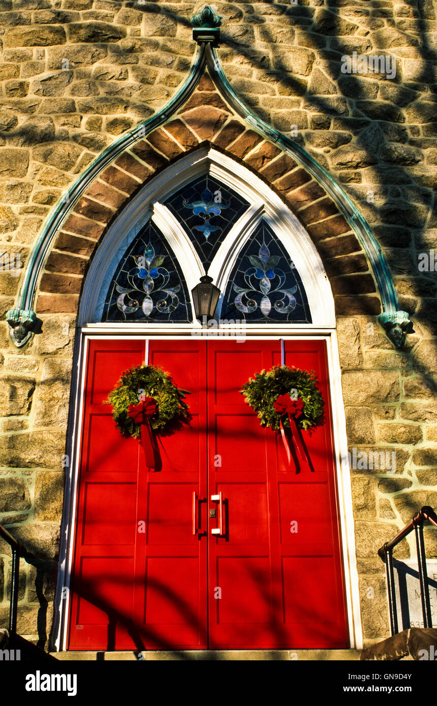 Close up red colour church door with Christmas wreath decoration in ...