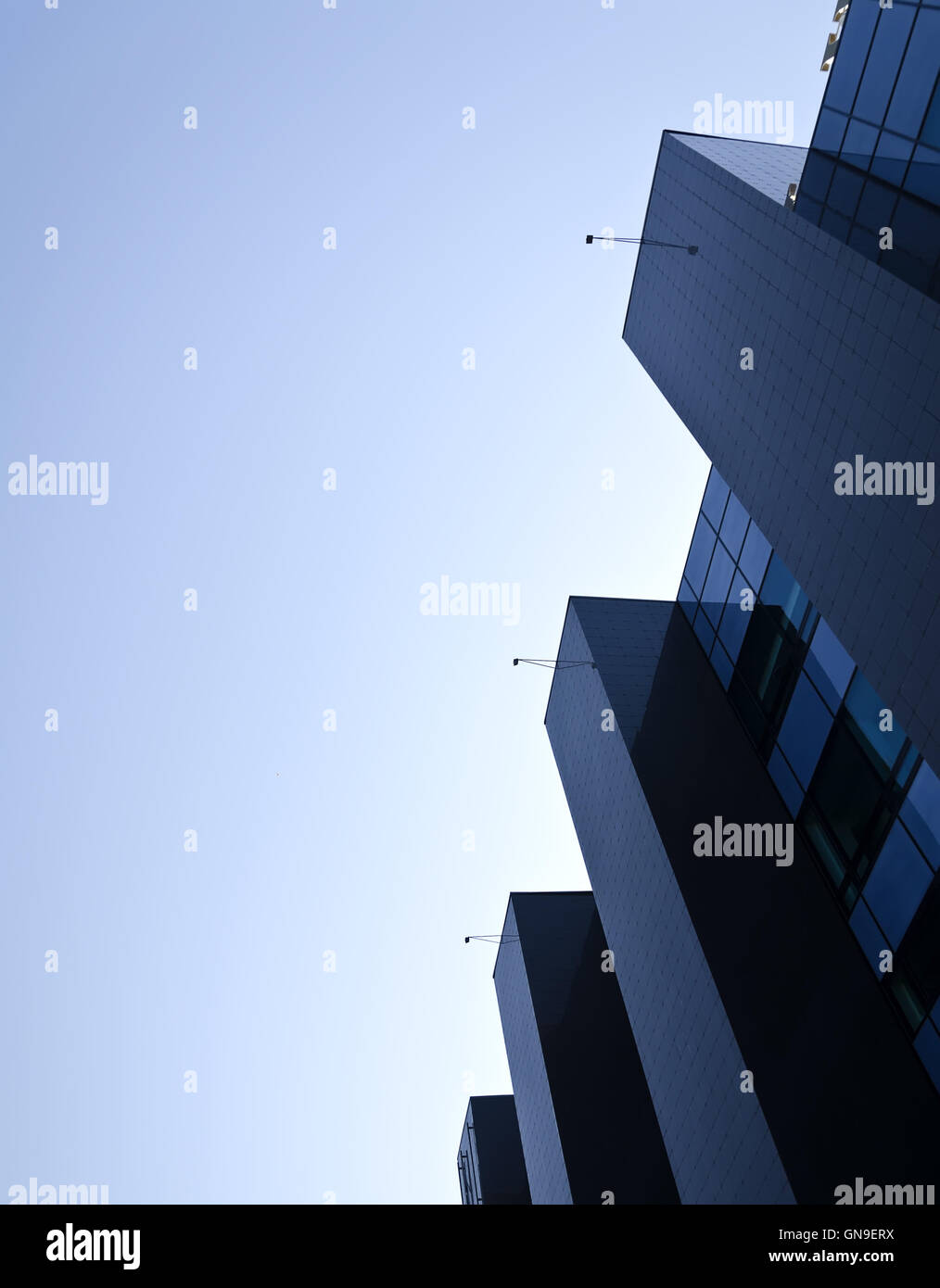 Office building under blue cloudless sky Stock Photo - Alamy