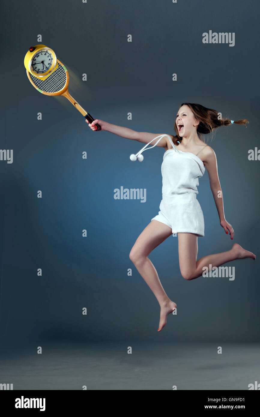 girl jumps up and hits the alarm clock Stock Photo - Alamy