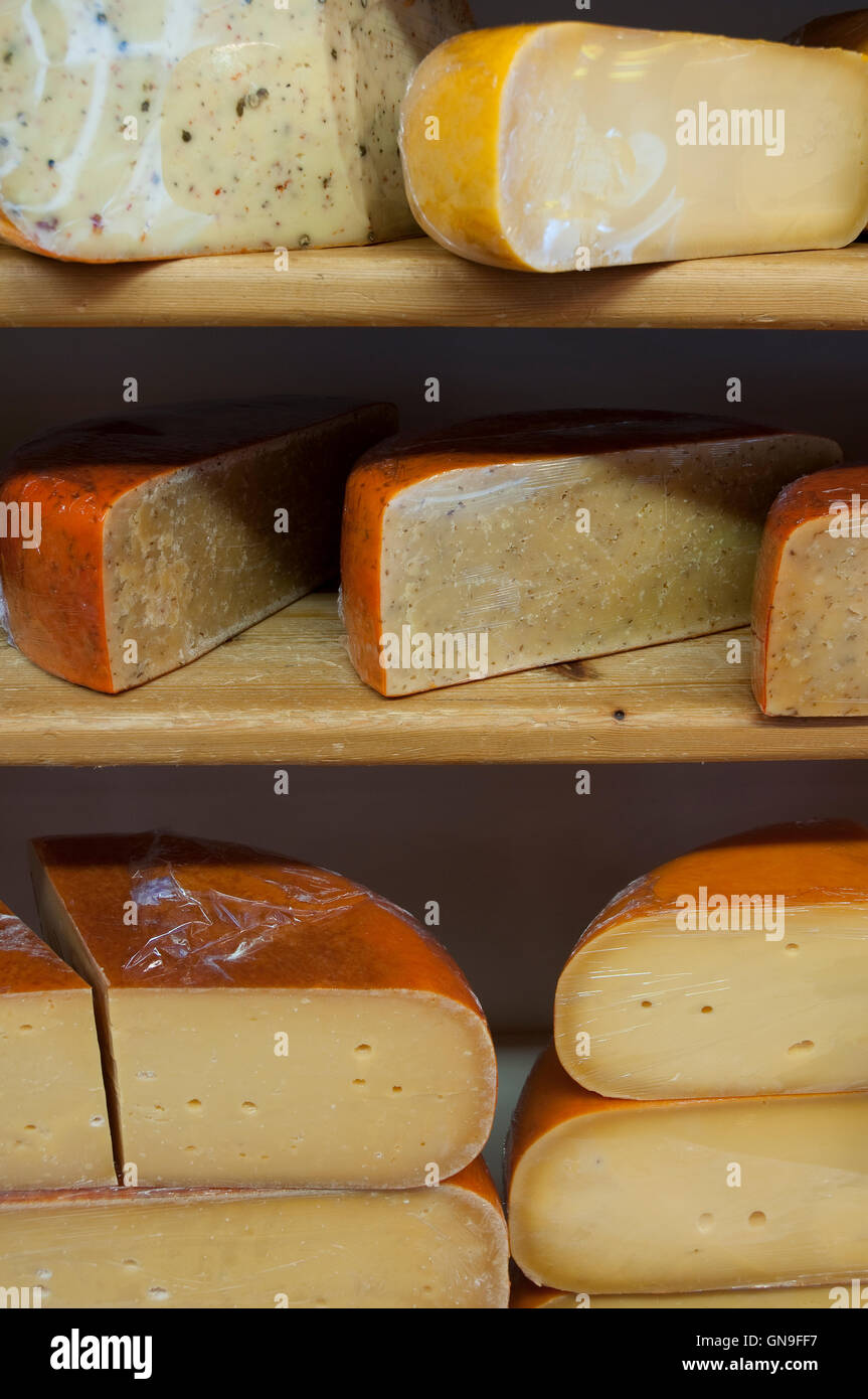 Cut cheese on shelves in store Stock Photo - Alamy
