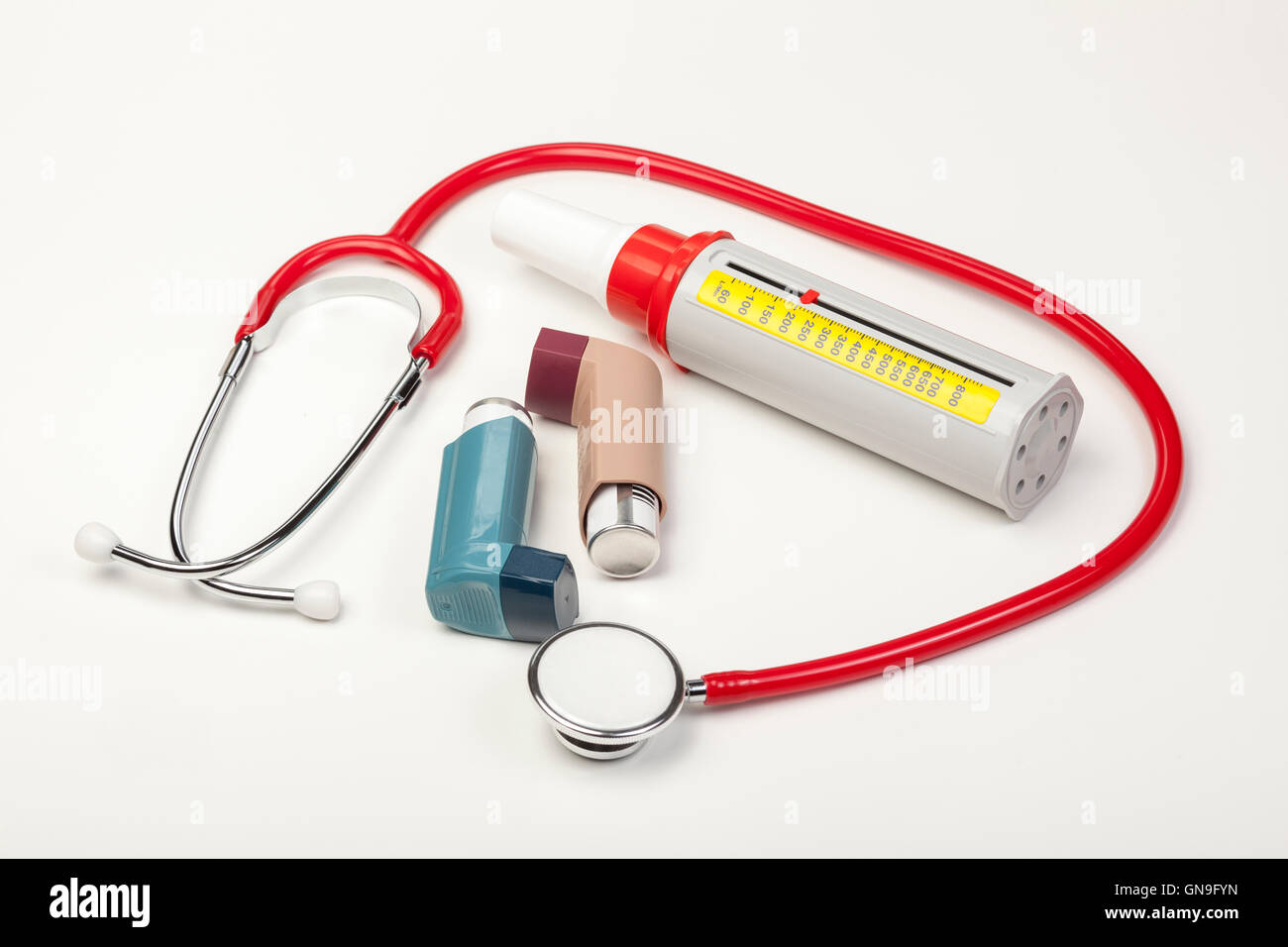 Two asthma inhalers with a peek flow meter surrounded by a red ...