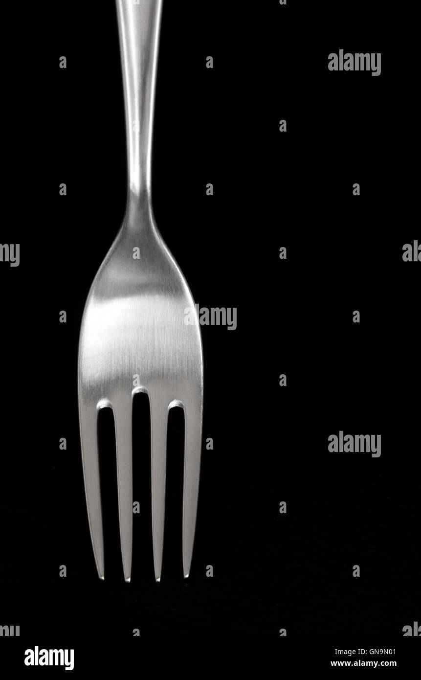 Shiny silver fork on black background Stock Photo - Alamy