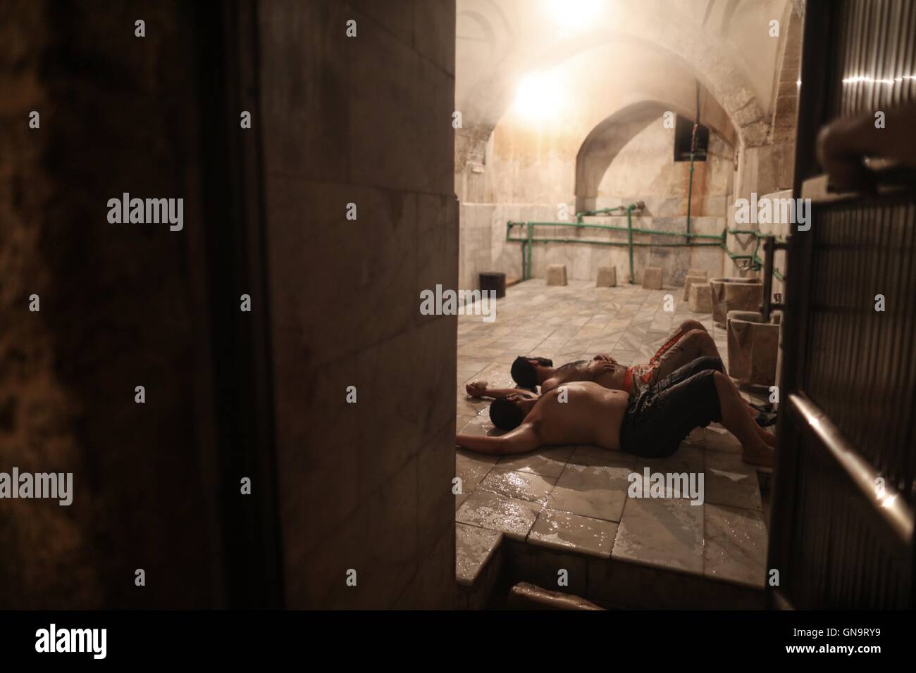 Gaza. 28th Aug, 2016. Palestinians take a steam bath at the ancient ...