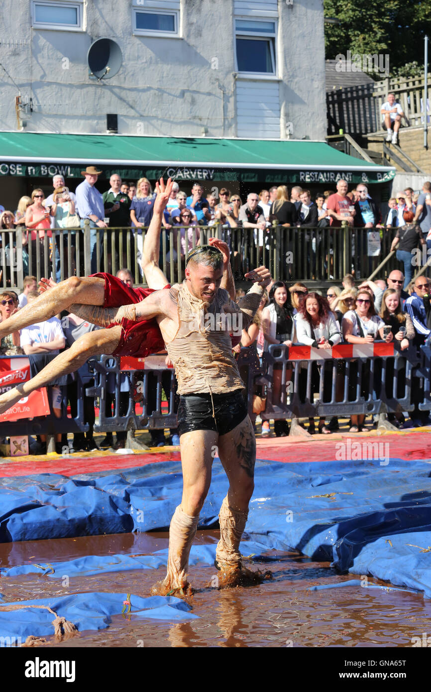 A man lifts his opponent in the gravy wrestling championship ...