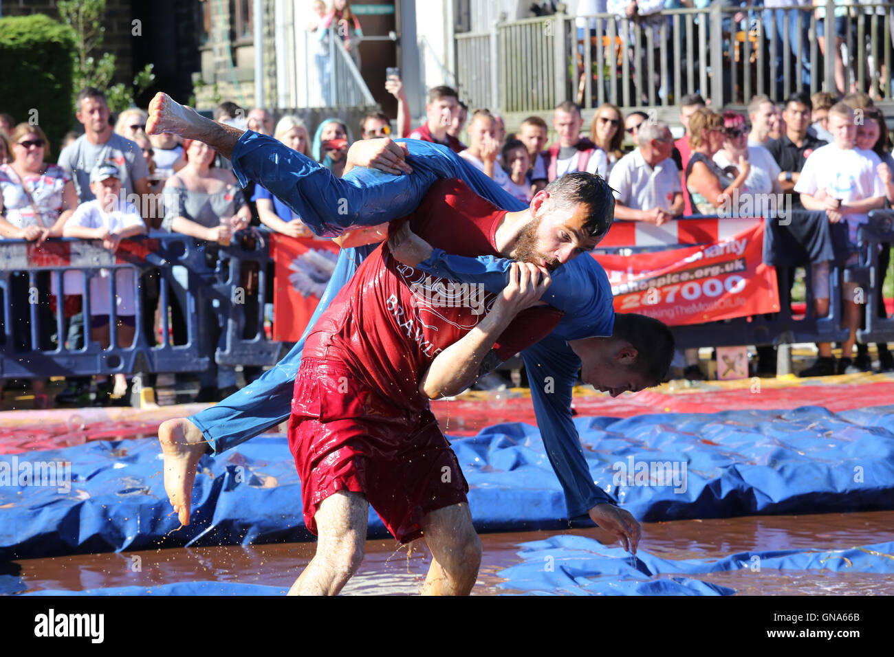 A gravy wrestling competitor lifts his opponent, Stacksteads,29th ...