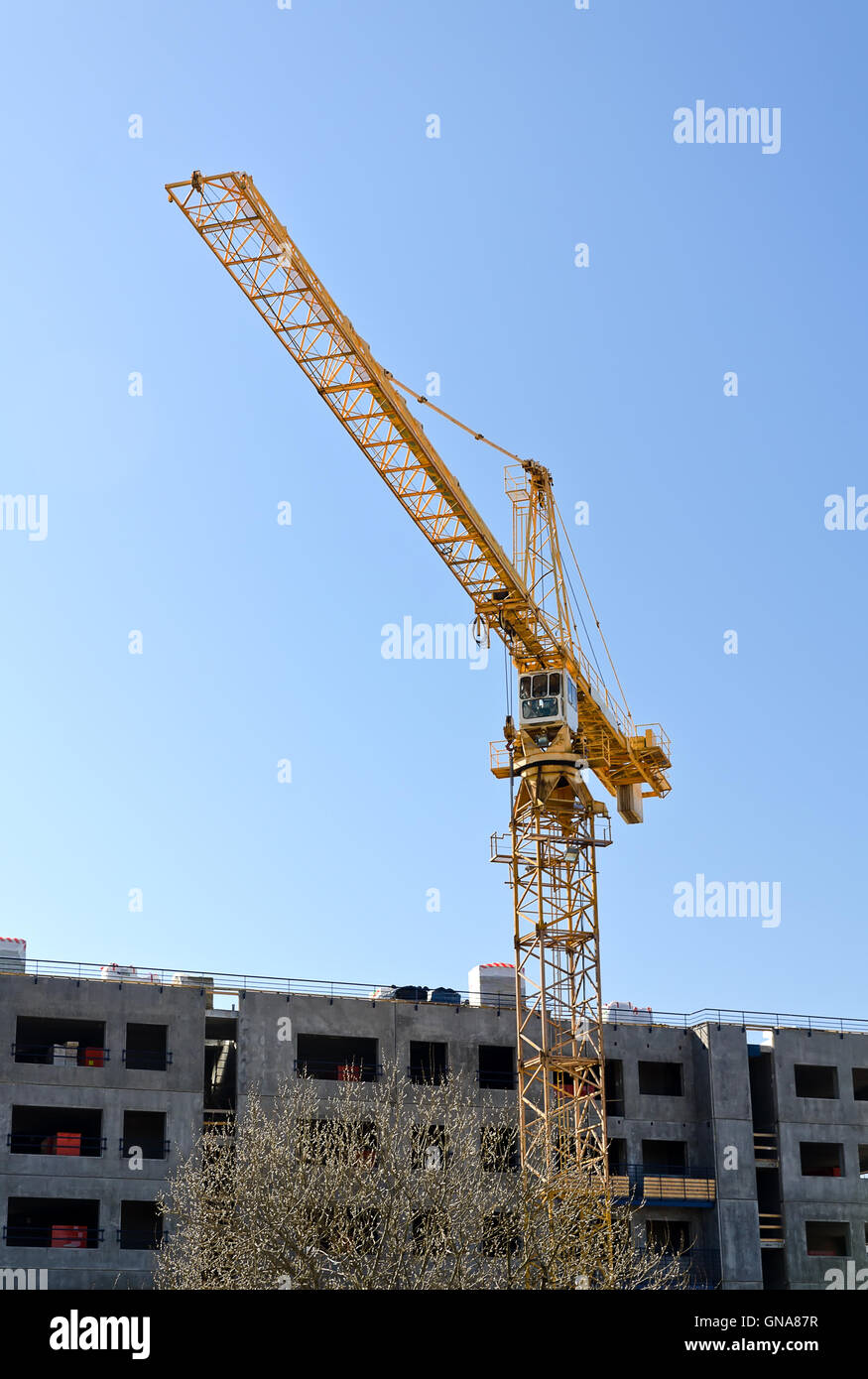 Tower crane near building under construction Stock Photo - Alamy
