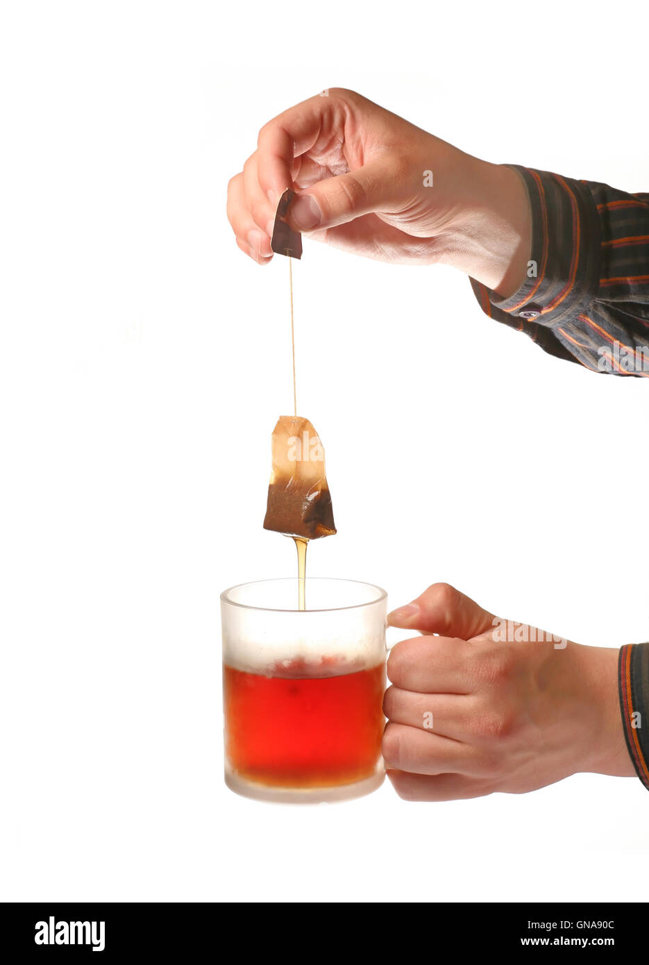 Mans hands holding tea cup and teabag Stock Photo - Alamy