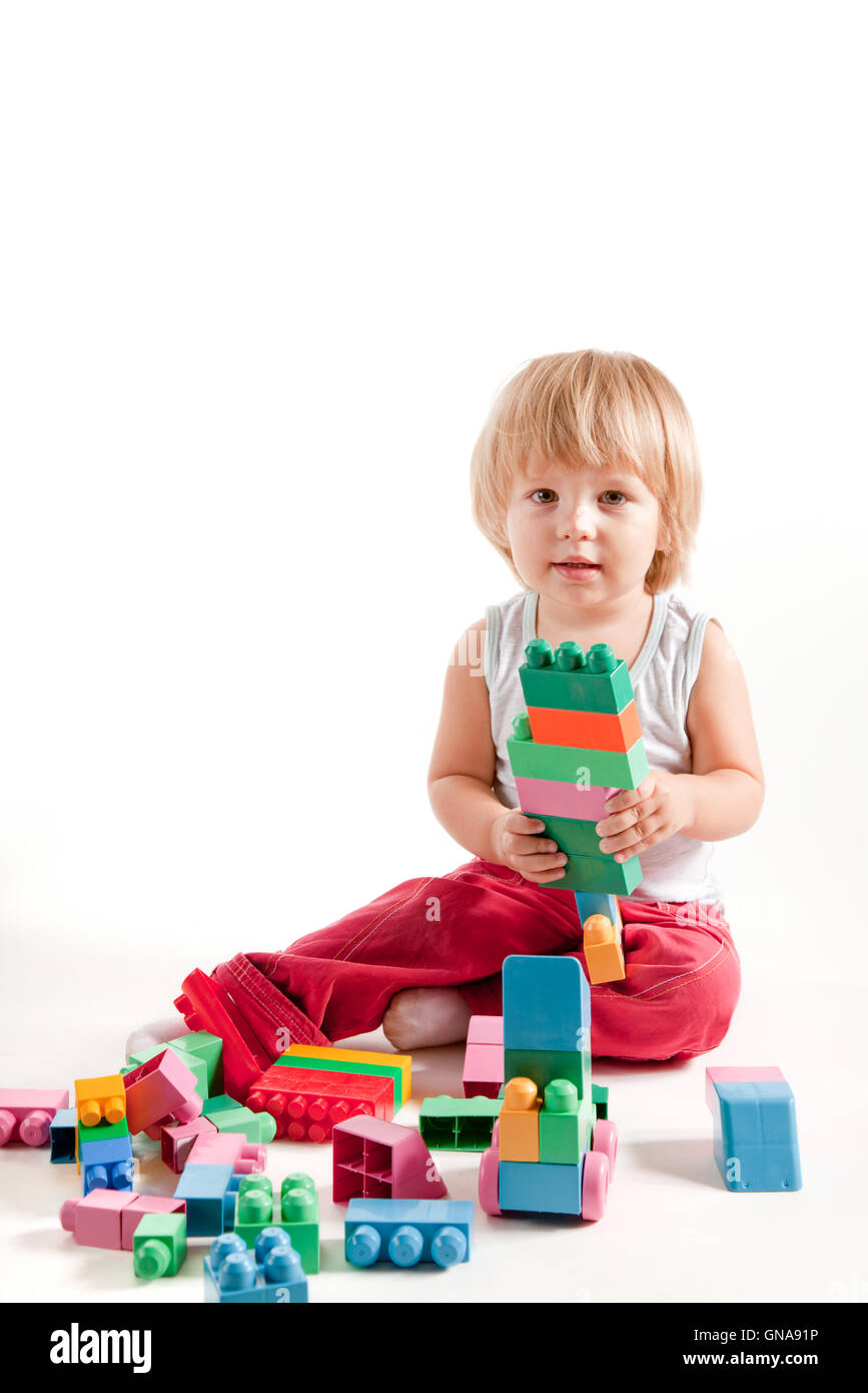 Funny little boy playing with blocks Stock Photo - Alamy