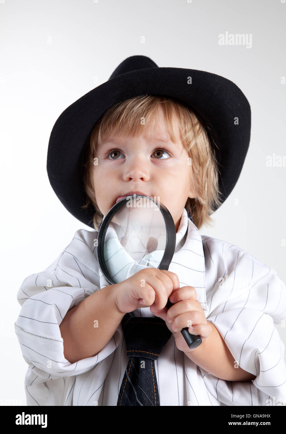 Young detective with magnifying glass Stock Photo - Alamy