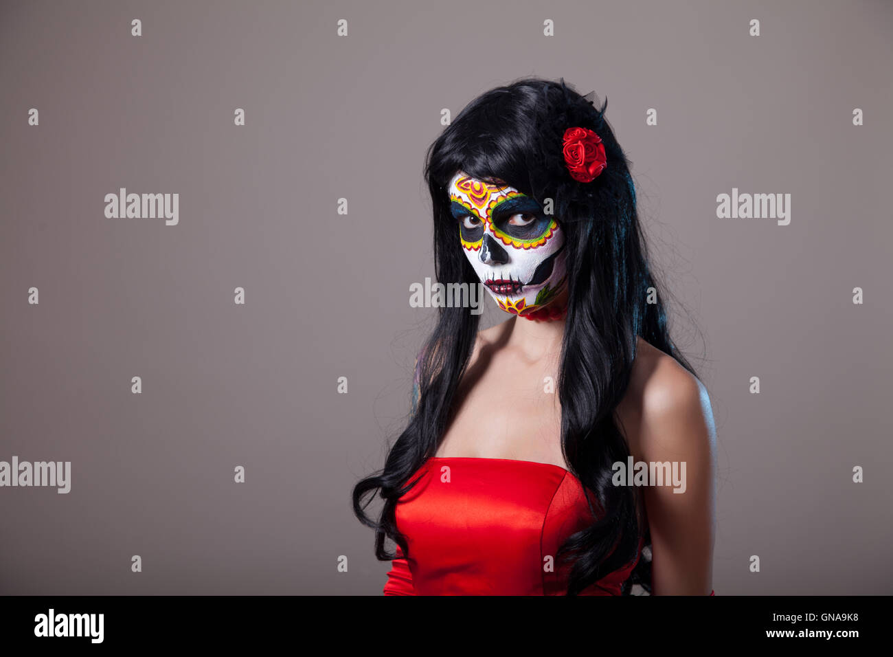 Sugar skull girl in red dress Stock Photo - Alamy