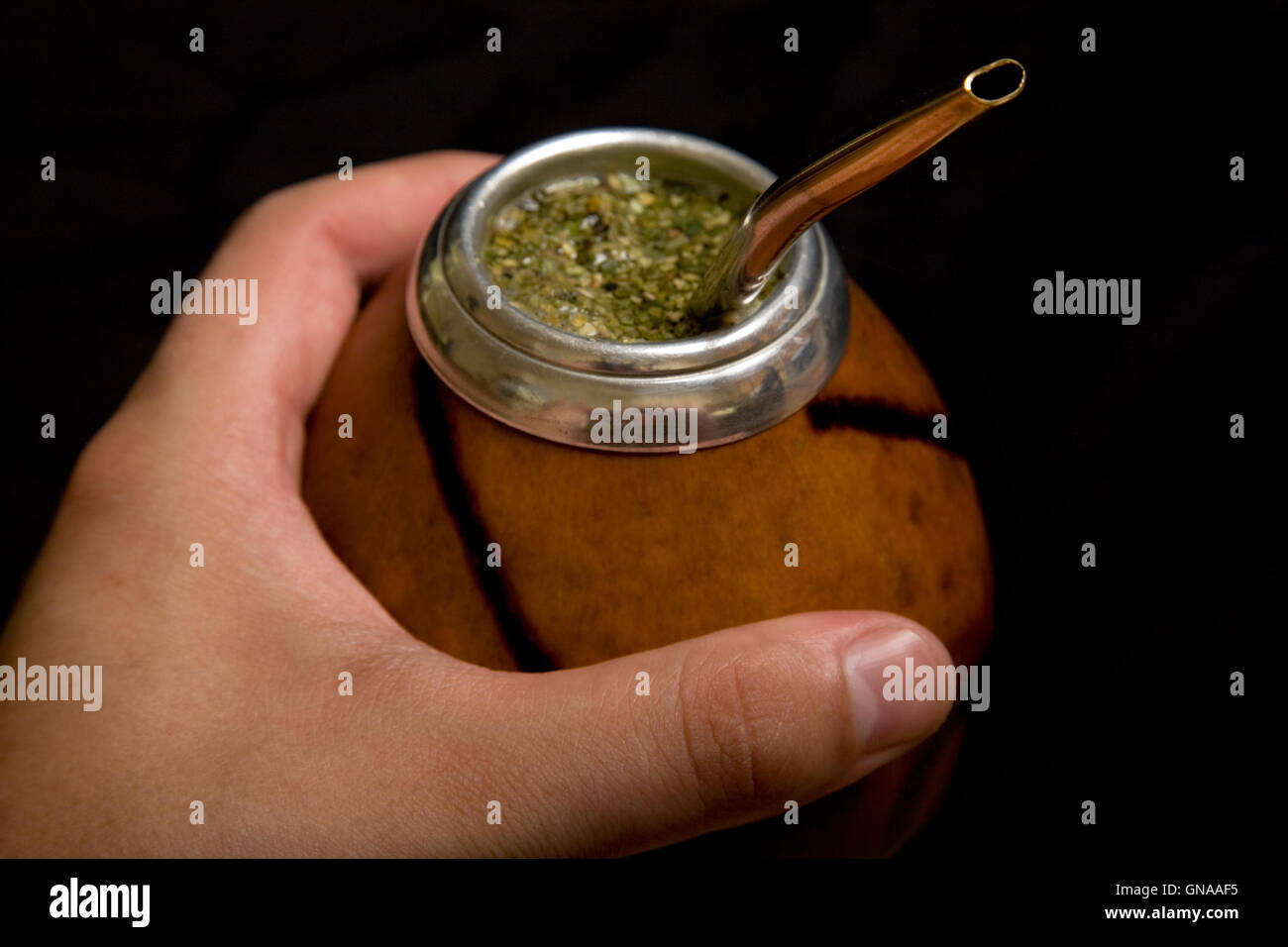 Male hand holding Calabash with Bombilla Stock Photo - Alamy