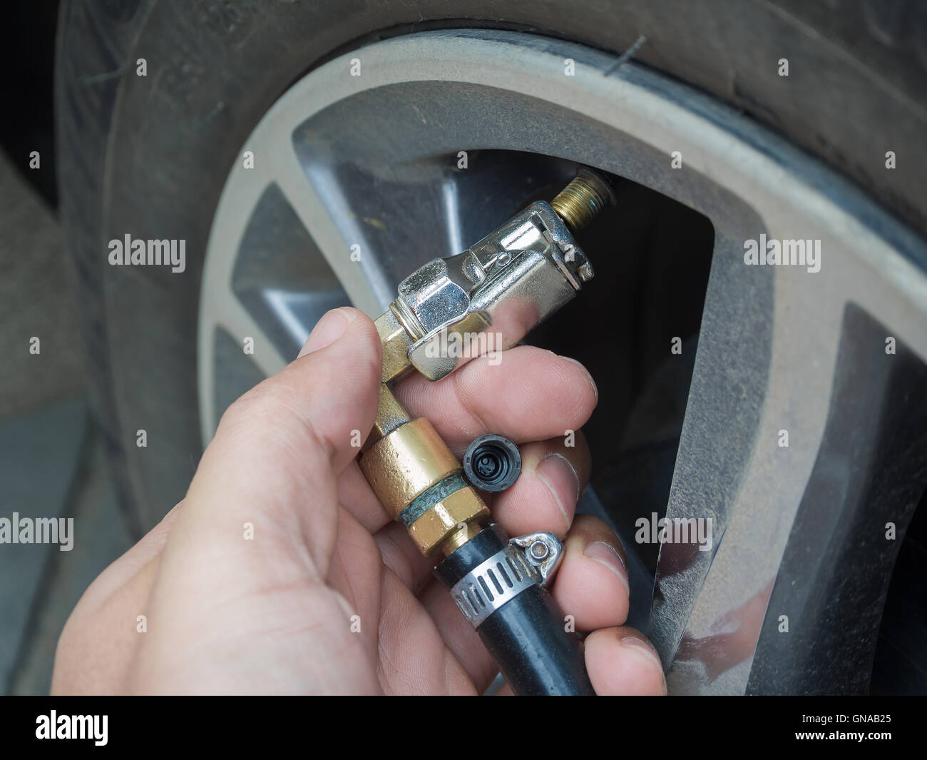 Closeup man checking air pressure and filling air in the tire Stock ...