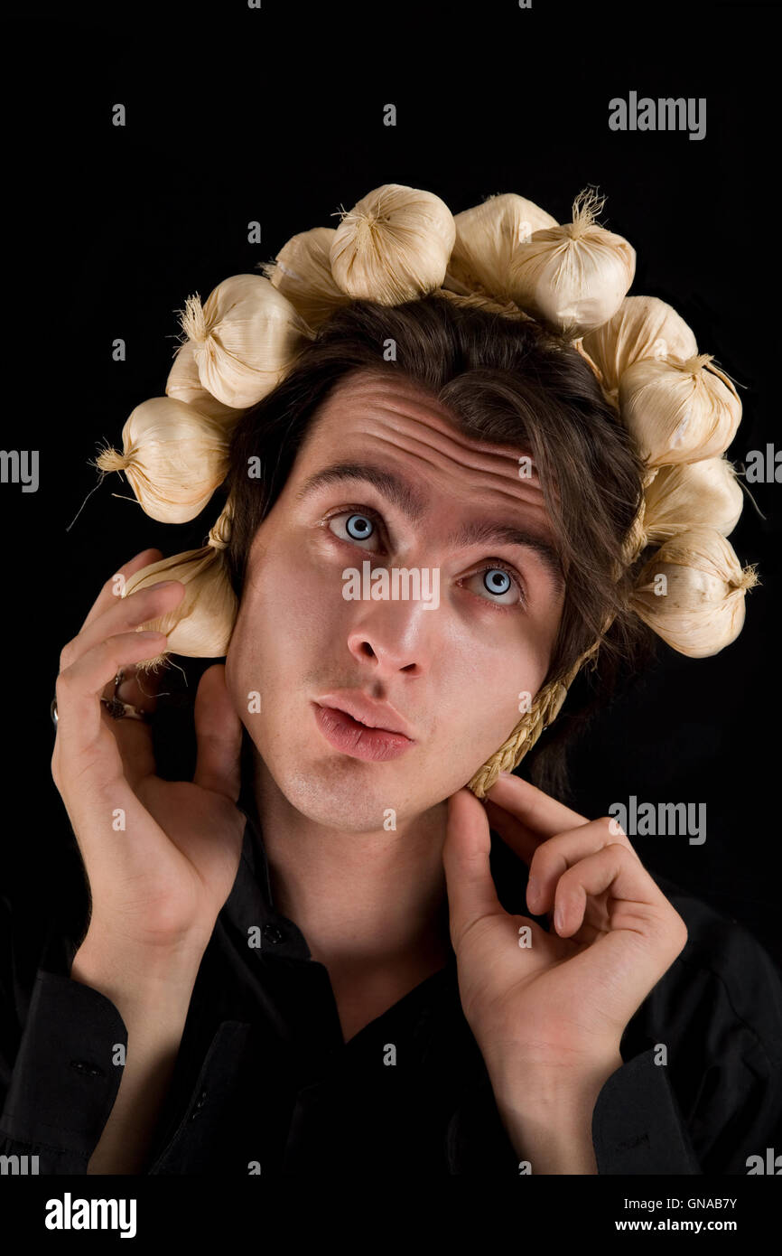Funny shot of vampire with garlic on his head Stock Photo - Alamy