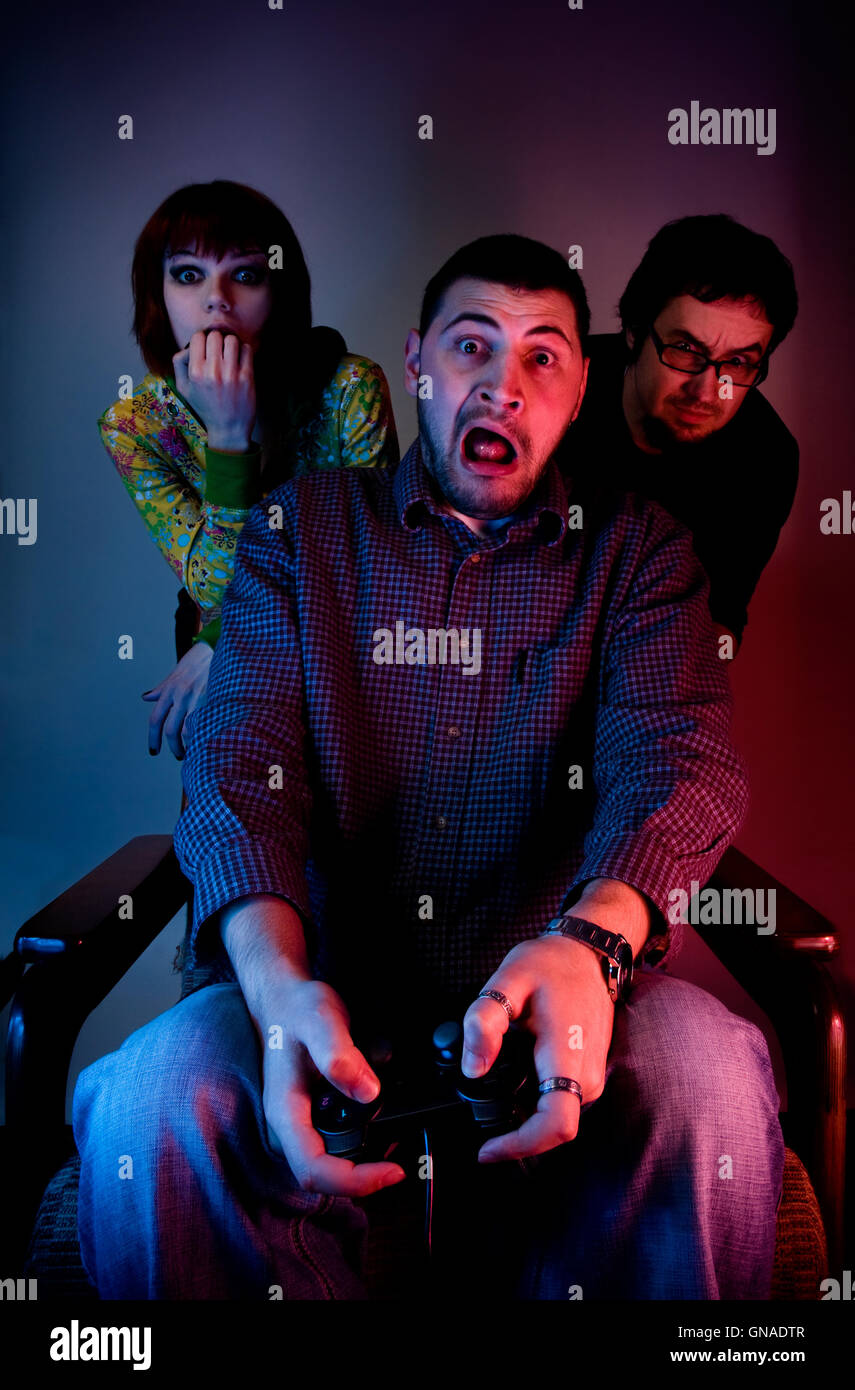 Young friends playing video games Stock Photo - Alamy