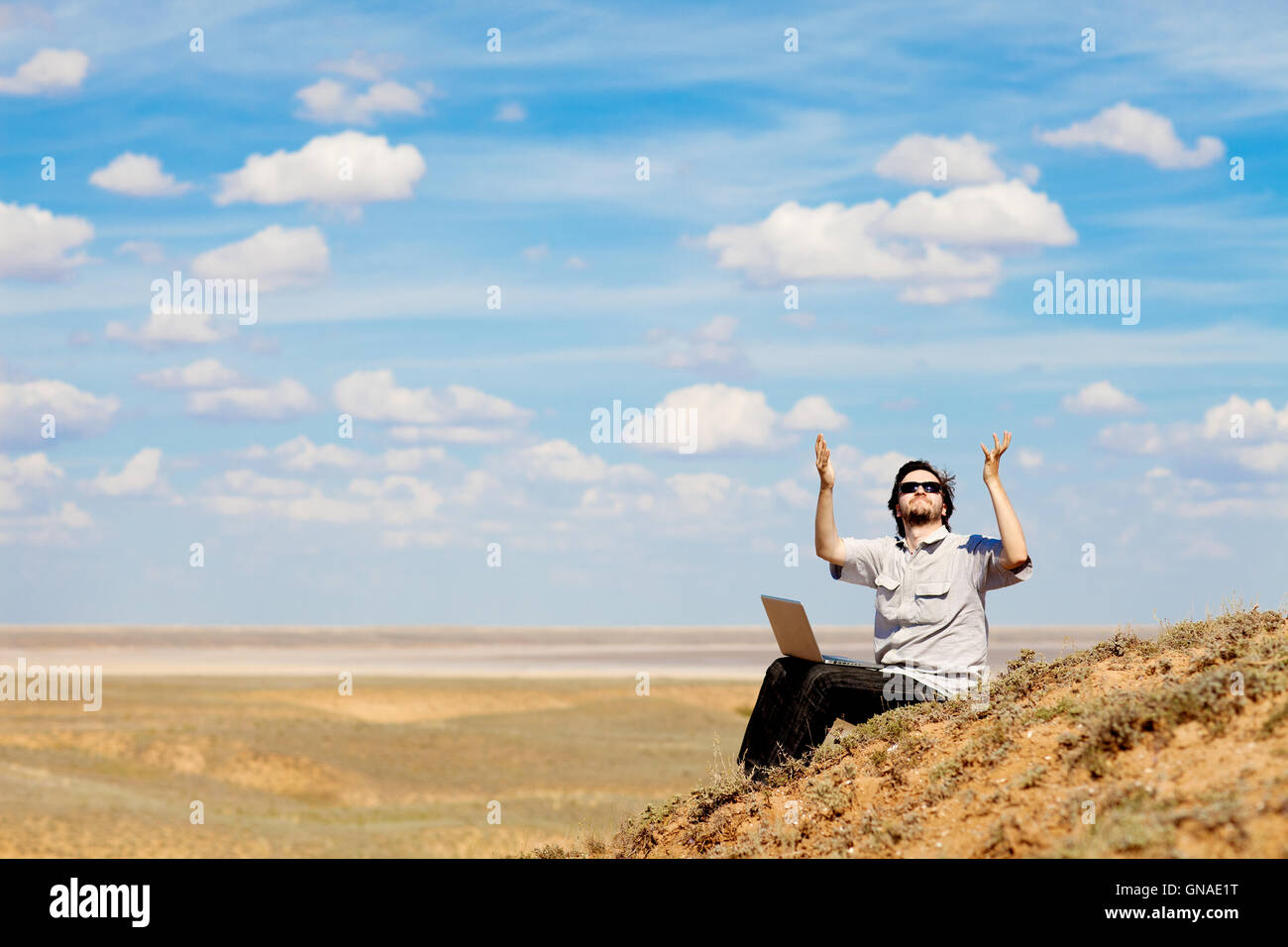 man with laptop praying to the God Stock Photo - Alamy