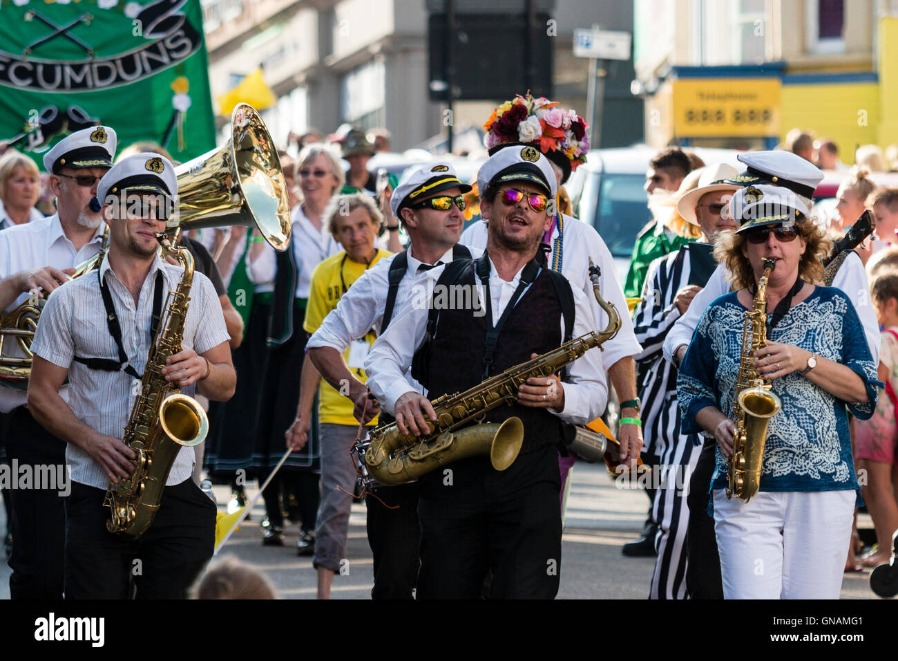 Members of Jazz band playing saxophones while walking and leading the ...