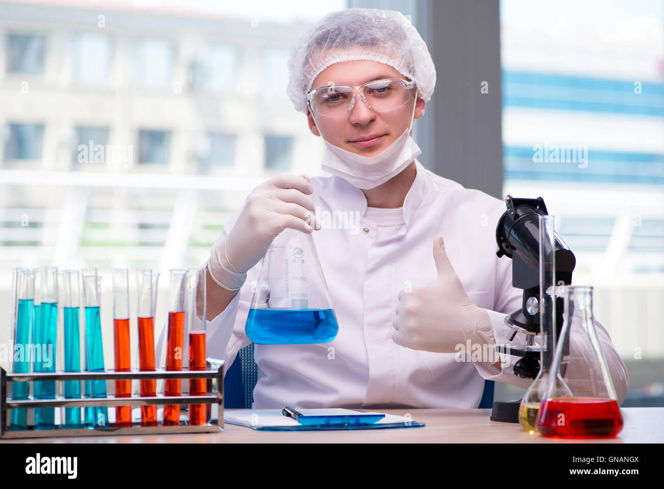 Man working in the chemical lab on science project Stock Photo - Alamy