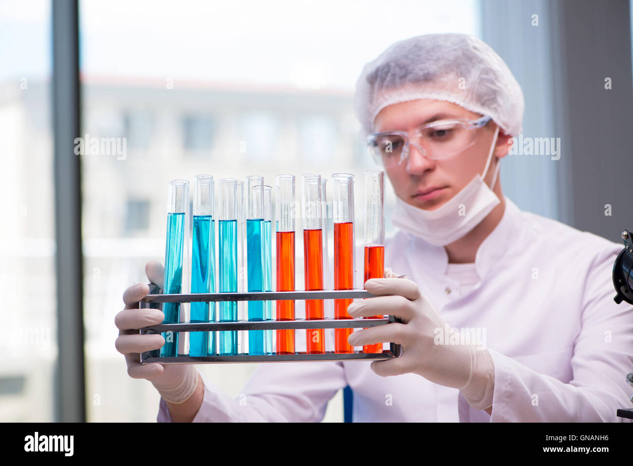Man working in the chemical lab on science project Stock Photo - Alamy