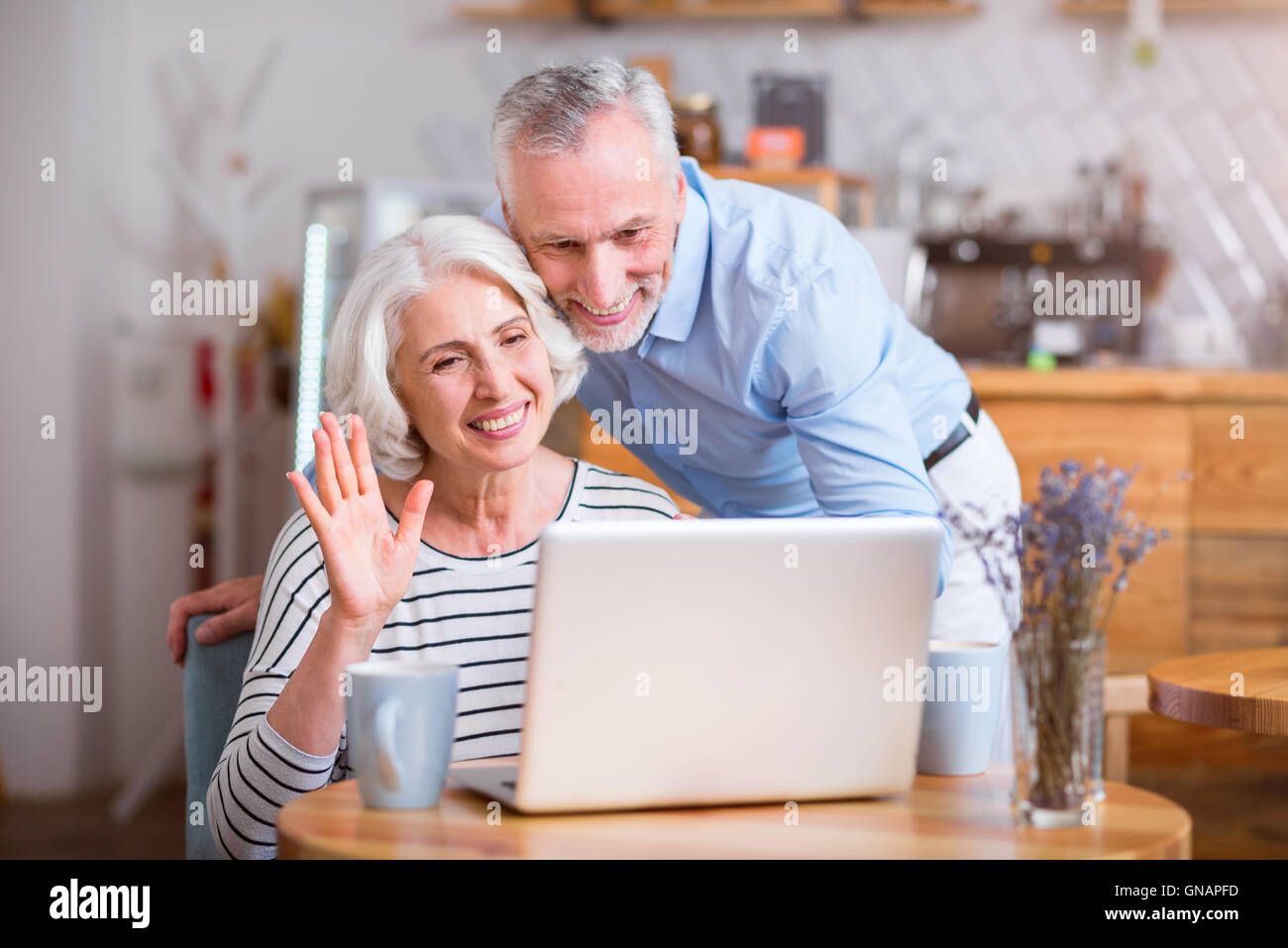Positive senior couple using laptop Stock Photo - Alamy