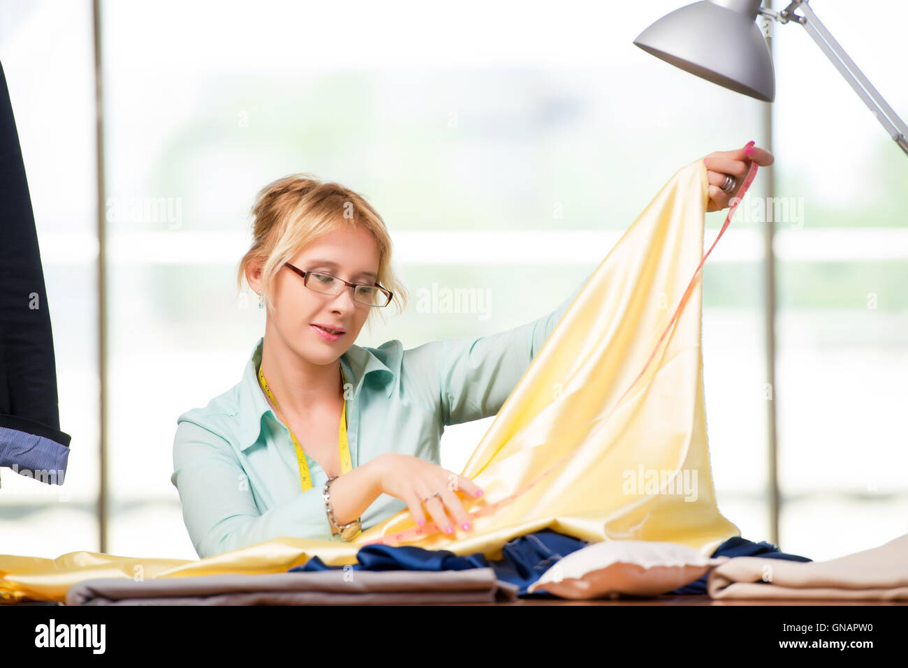 Woman tailor working on new clothing Stock Photo - Alamy