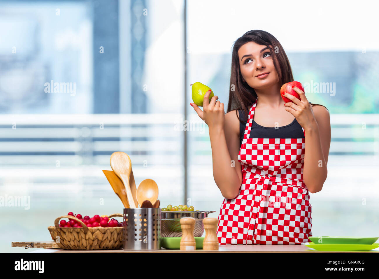 Young cook with fruits in the kitchen Stock Photo - Alamy