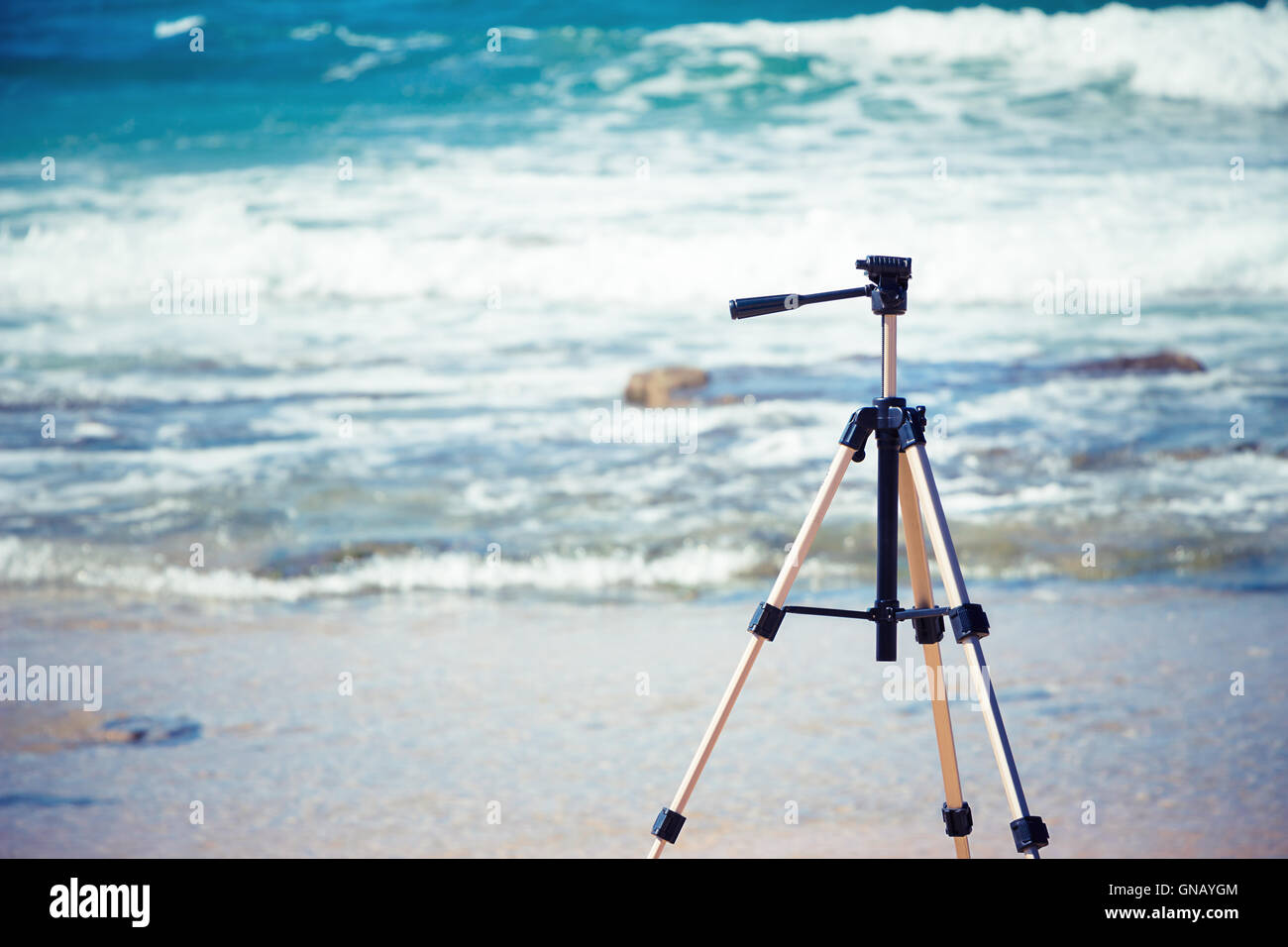 Tripod on the background of sea foam and waves. Device for the ...