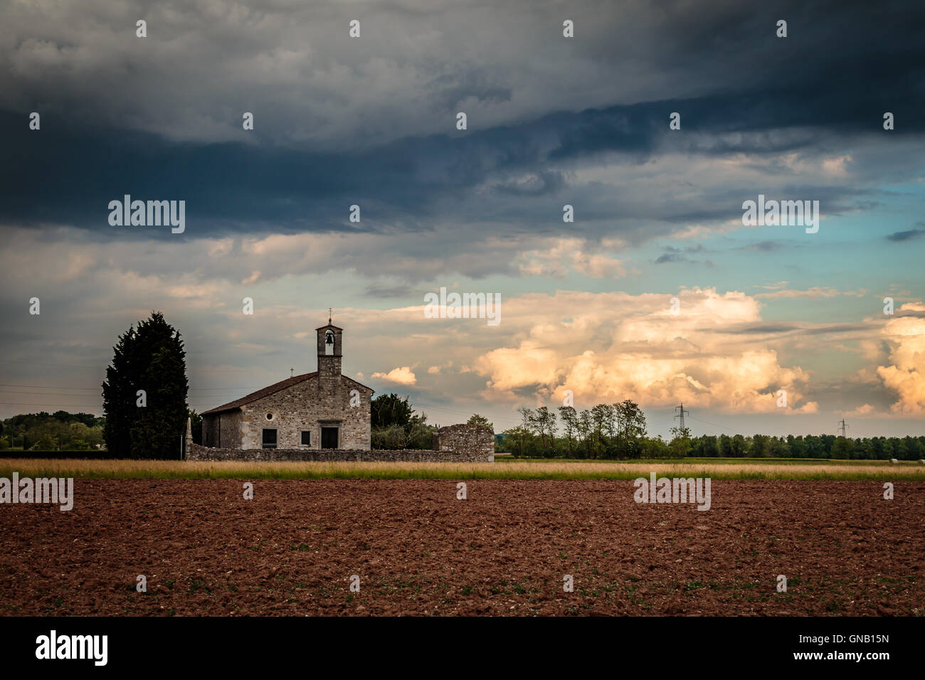 a storm is arriving on a little and old church in the italian ...