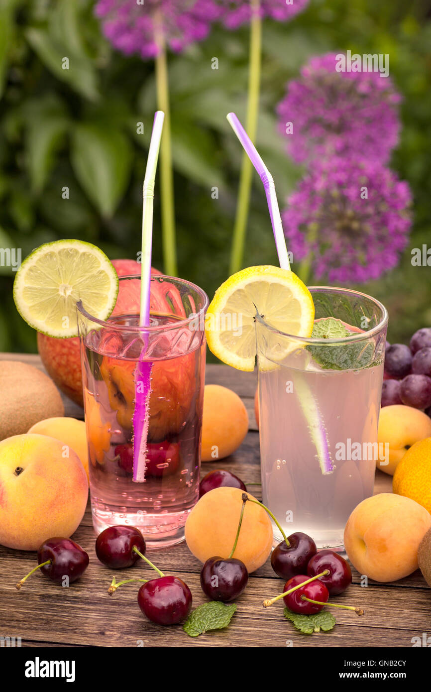 Fresh lemonade and ripe fruits vertical Stock Photo - Alamy