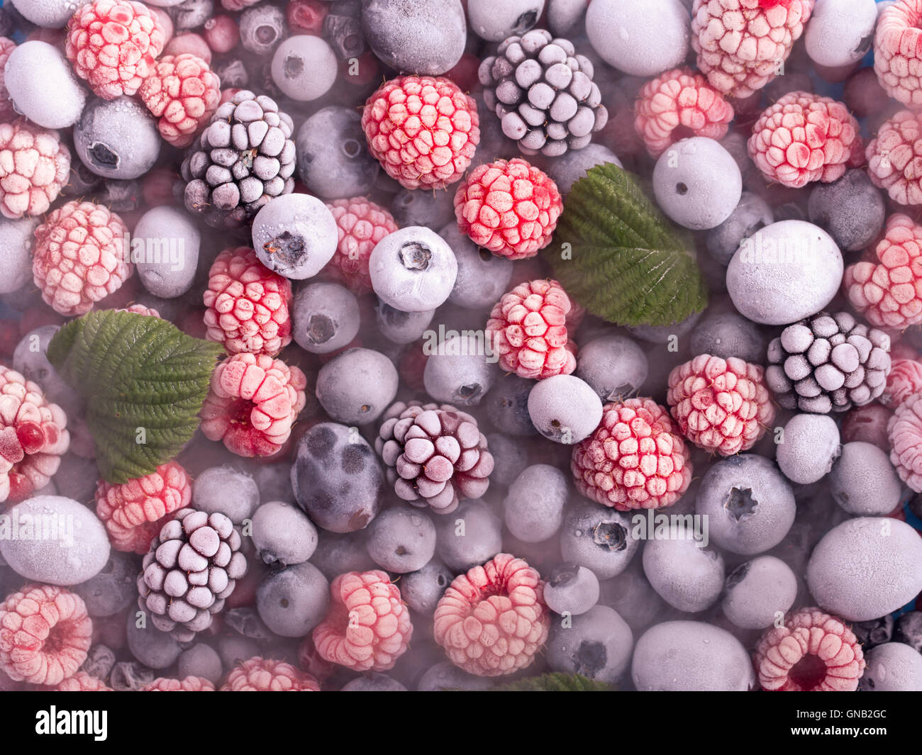 Frozen assorted berries background Stock Photo - Alamy