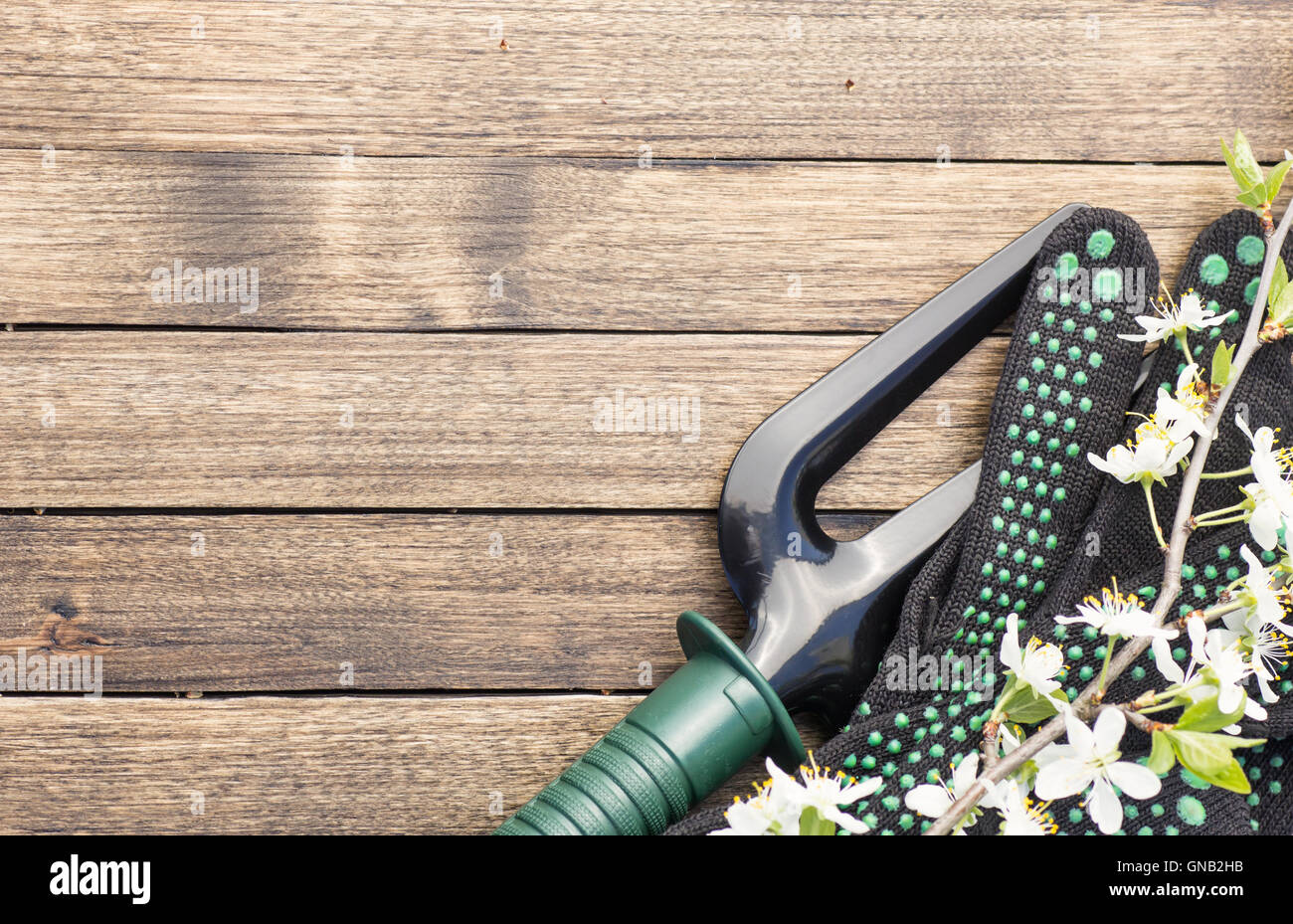 Garden tools at lower right corner of wooden background Stock Photo - Alamy