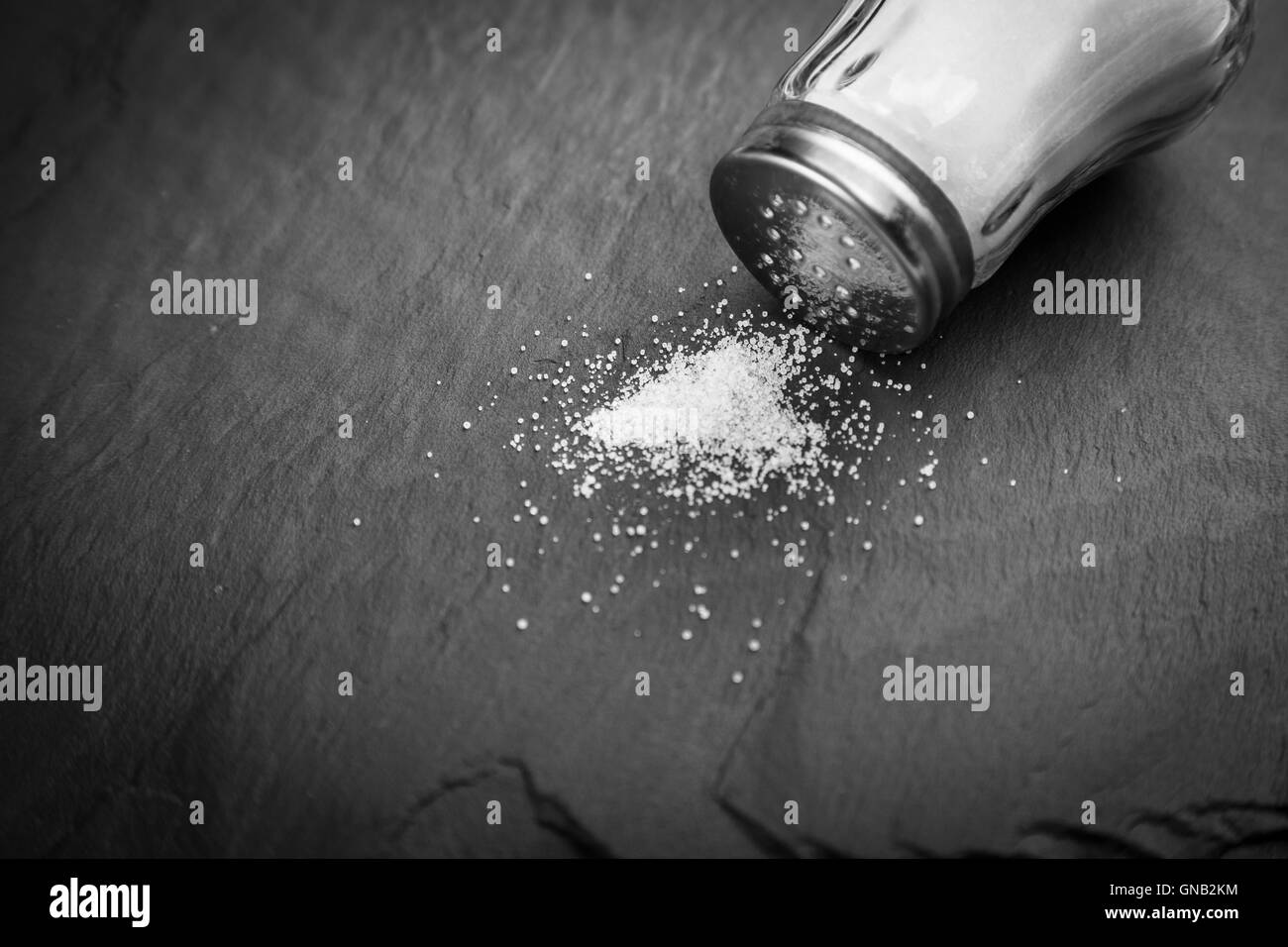 Salt shaker on slate board Stock Photo - Alamy