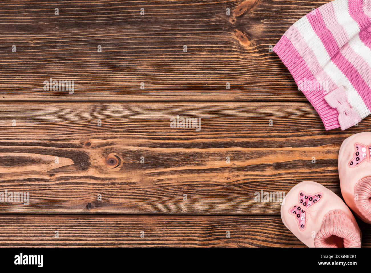 Baby clothes on wooden background Stock Photo - Alamy