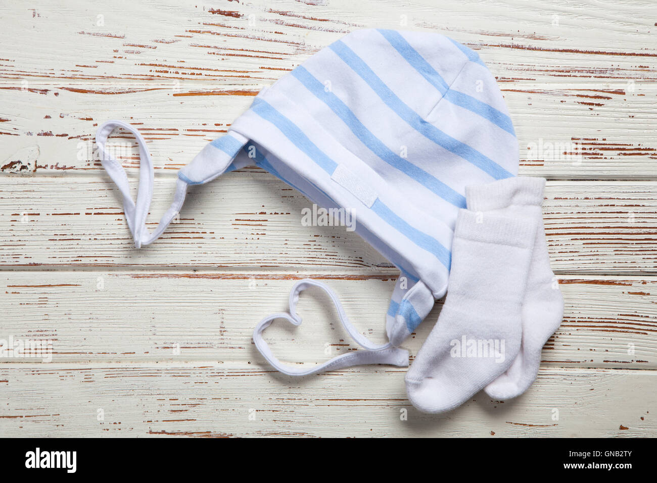Baby clothes on wooden background Stock Photo - Alamy