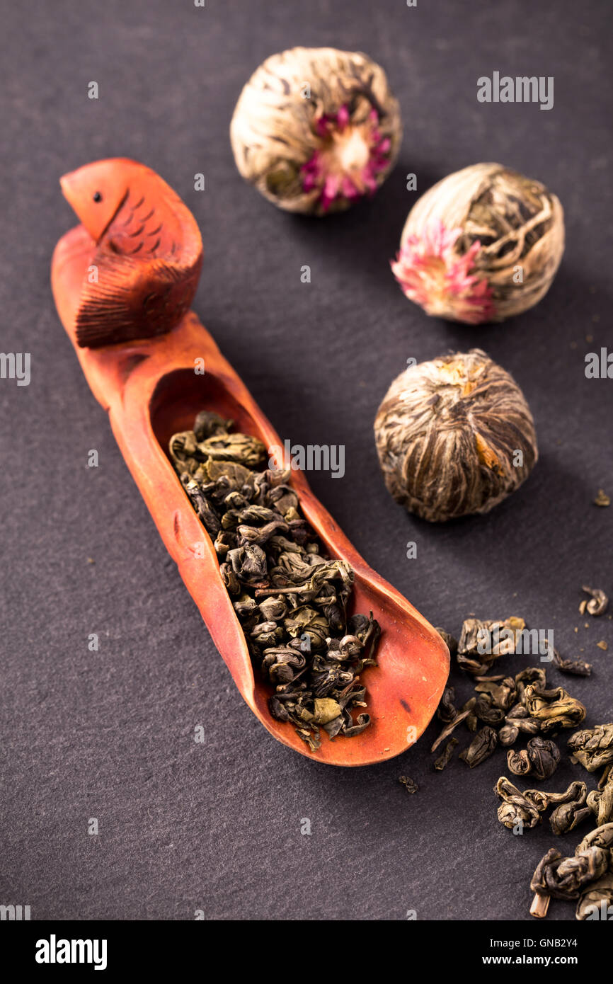 Green tea in handmade shovel on slate Stock Photo - Alamy